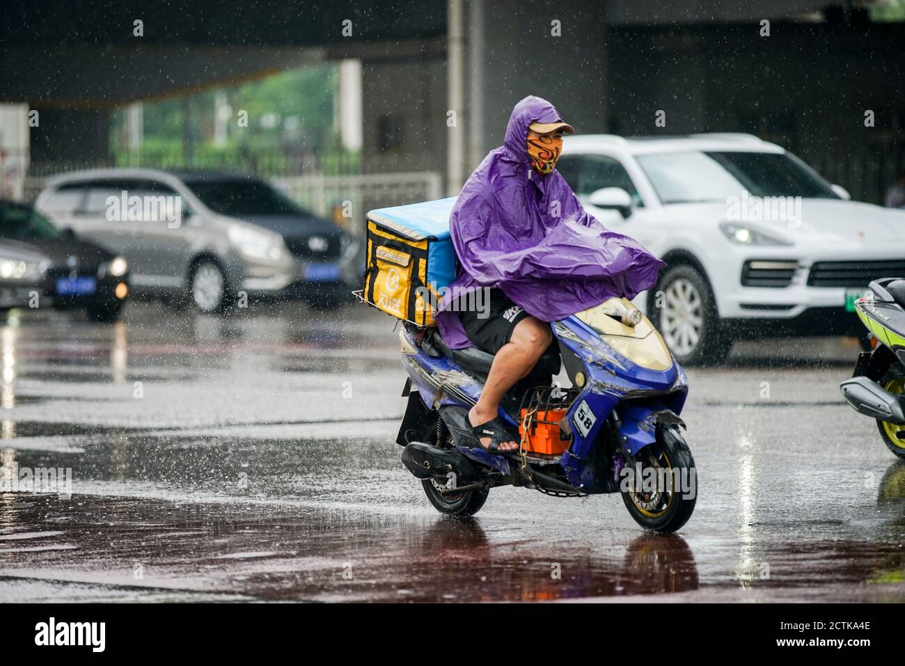 Motor, pedestrians and vehicles trek in the downpour, Beijing, China ...