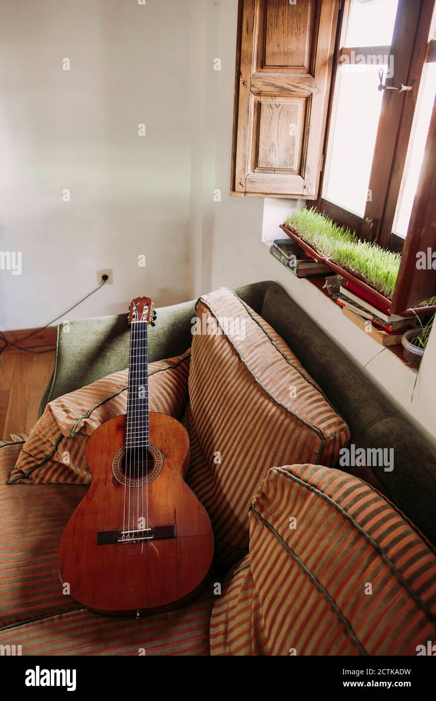 Guitar on sofa in living room Stock Photo - Alamy