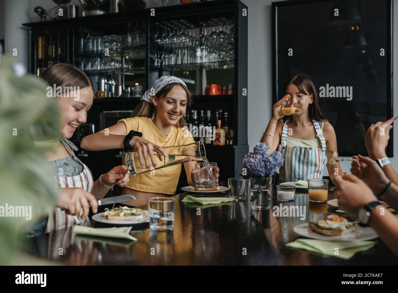 Group of teenage girls meeting for homemade brunch Stock Photo - Alamy