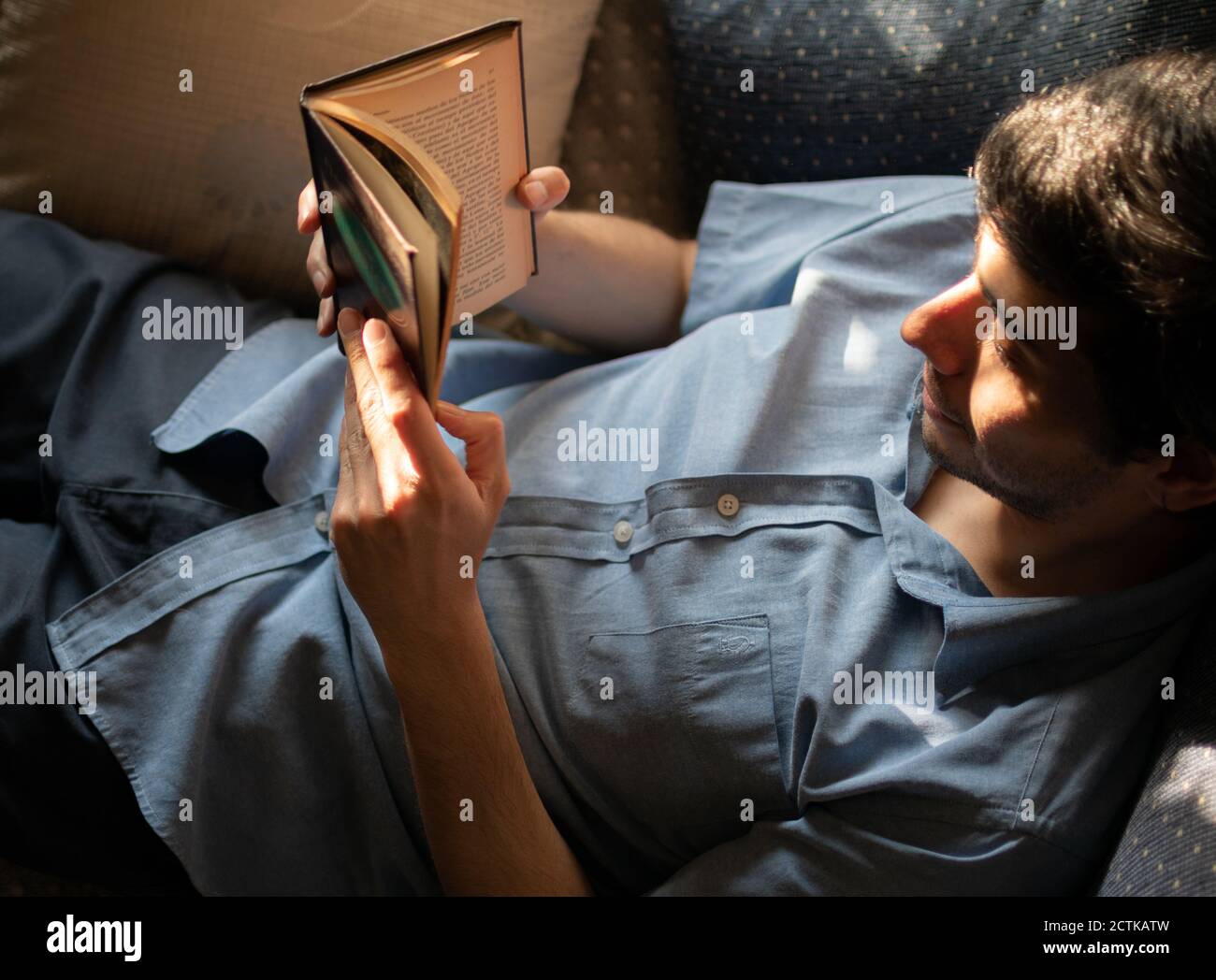 Home alone man reading hi-res stock photography and images - Alamy