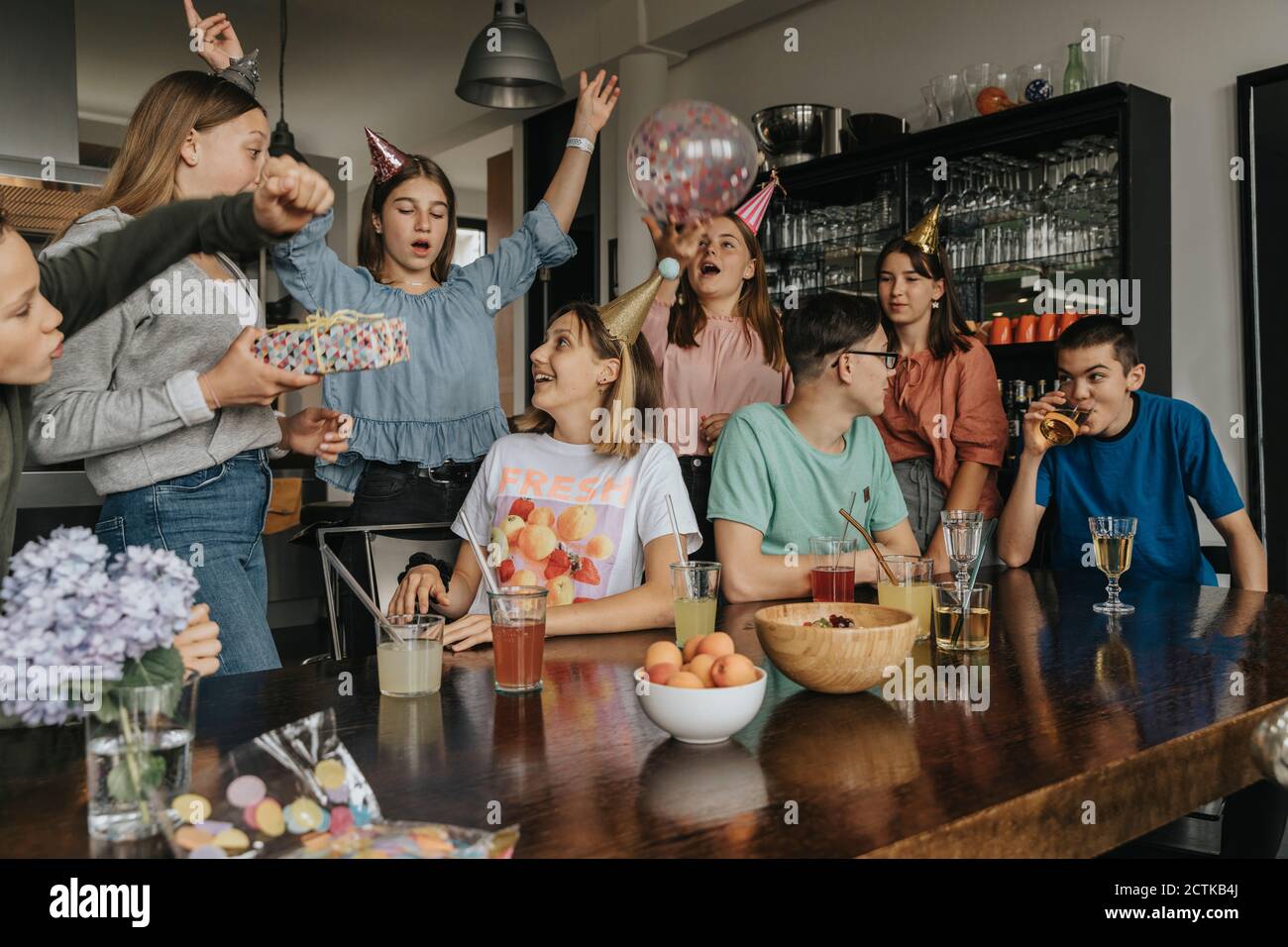 Cheerful friends enjoying birthday party at home Stock Photo - Alamy