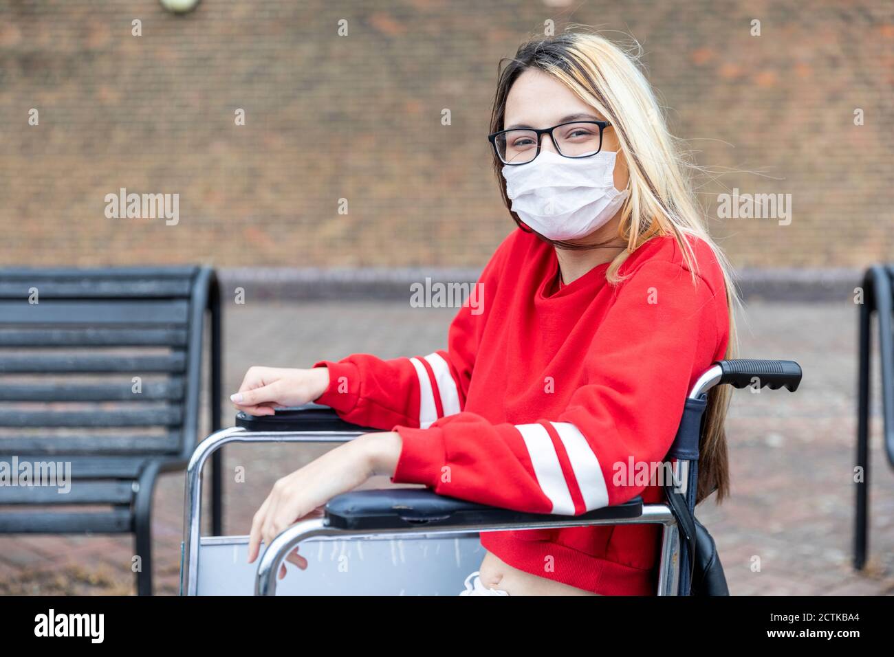 Disabled woman on wheelchair wearing face mask during coronavirus ...