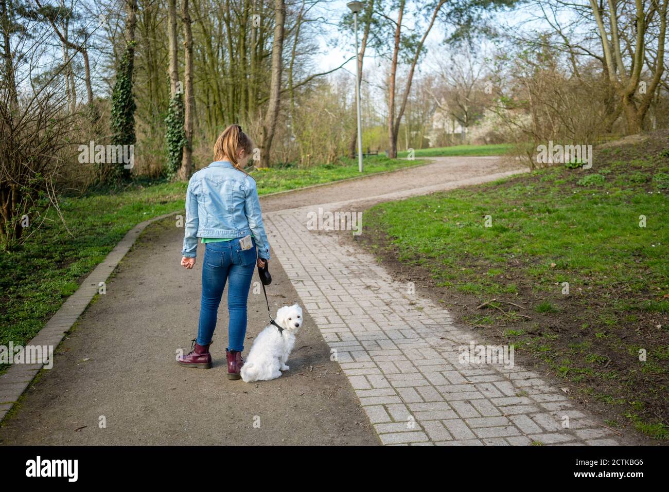 Girl standing with her dog hi-res stock photography and images - Alamy