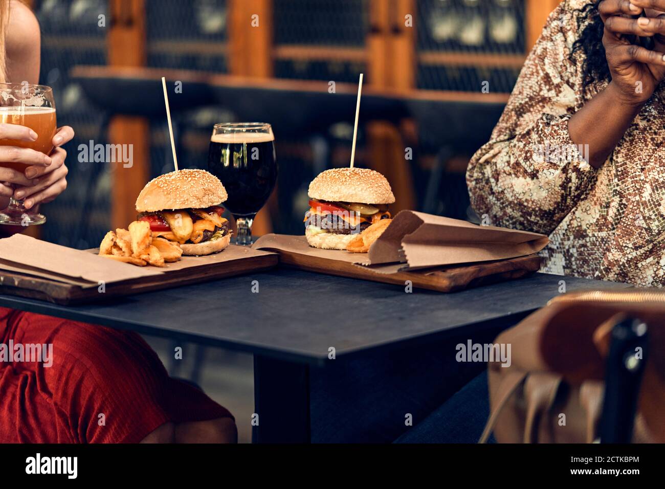 Friends having burger together restaurant hi-res stock photography and ...