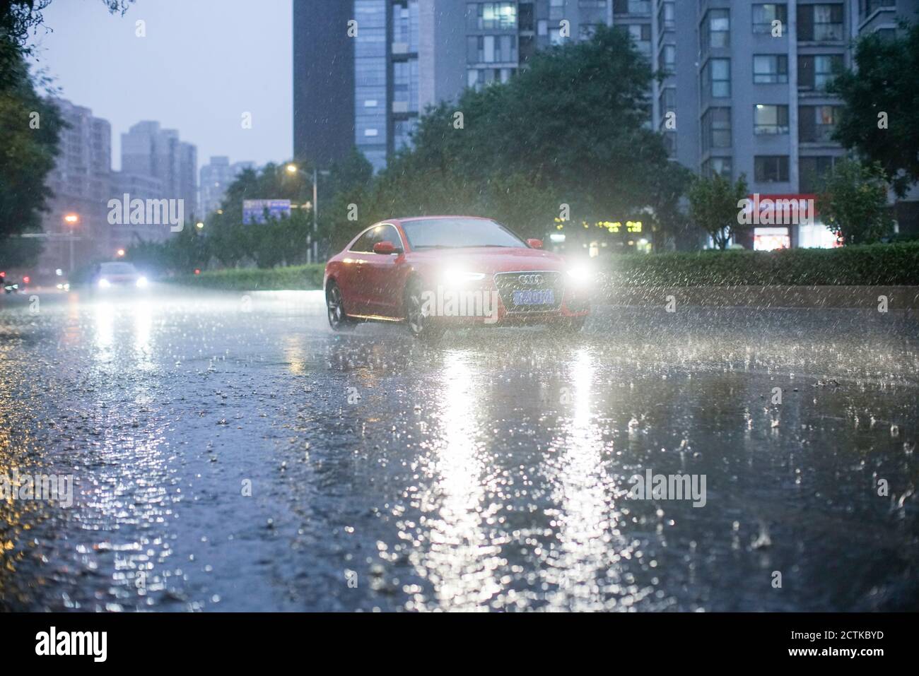 Motor, pedestrians and vehicles trek in the downpour, which might be ...