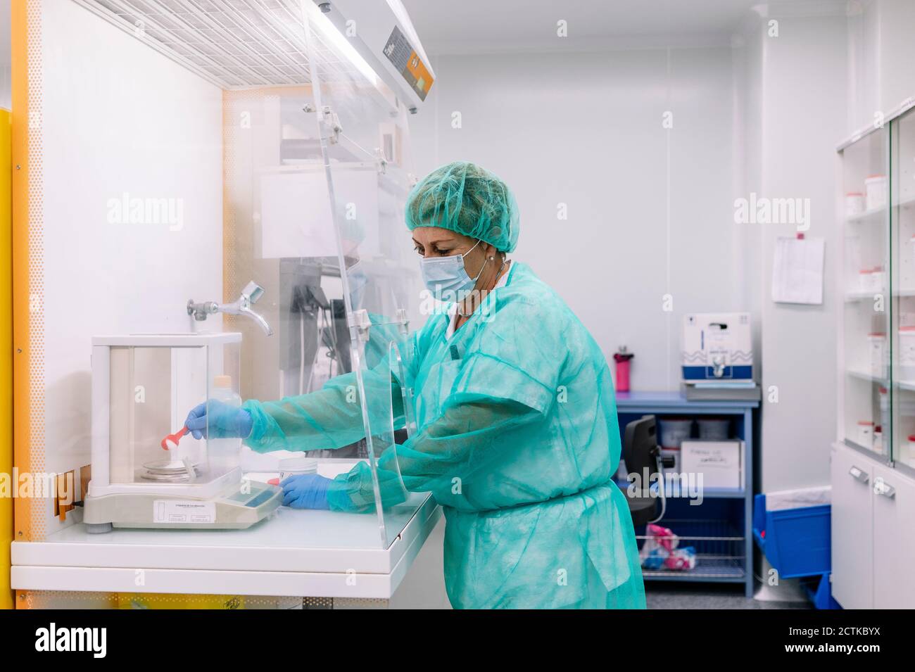 Female scientist measuring powder medicine on scale in laboratory Stock ...
