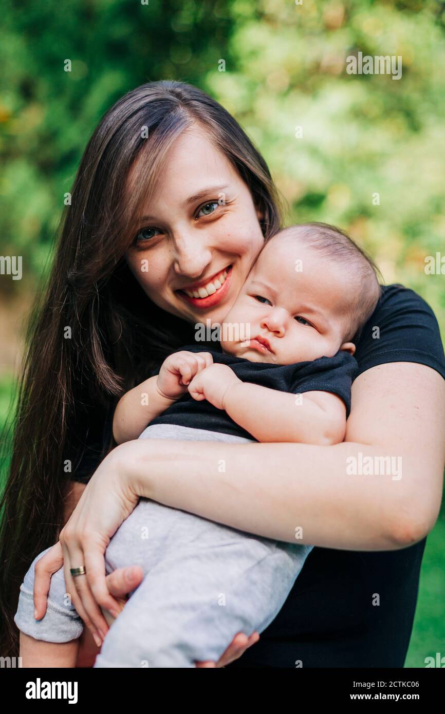 Woman carrying baby hi-res stock photography and images - Alamy