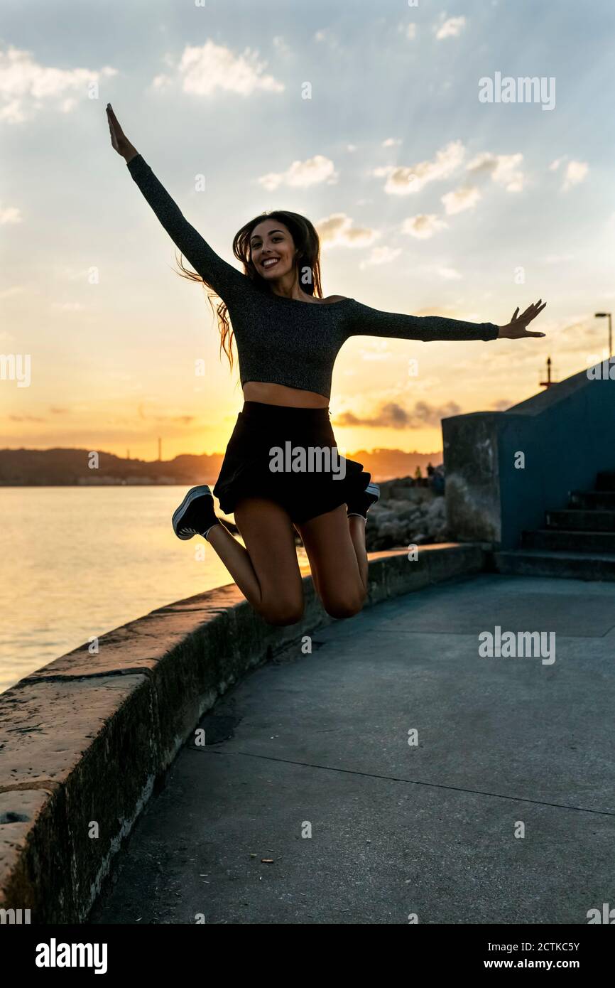 Women sunset jumping hi-res stock photography and images - Alamy