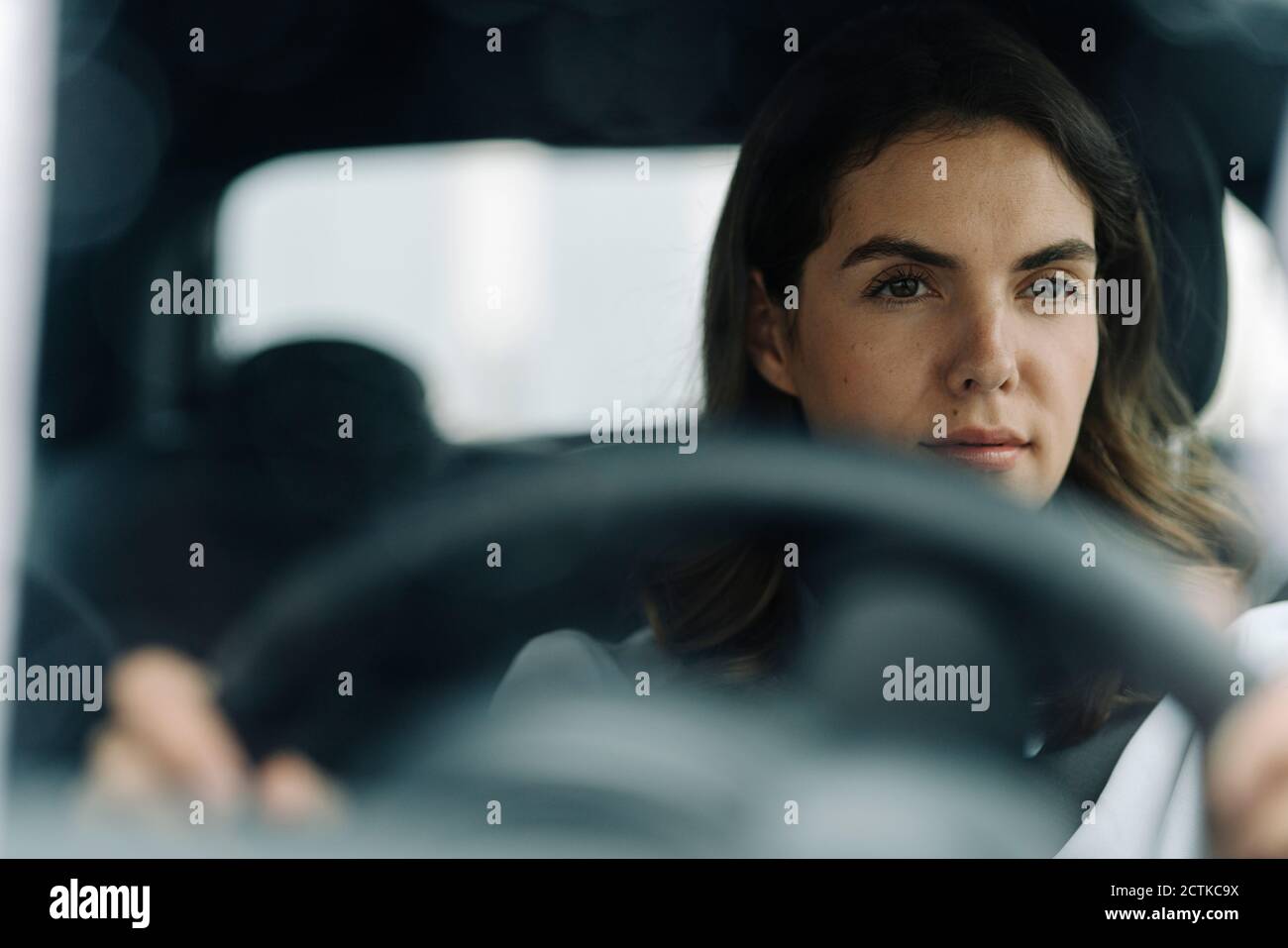 Young woman driving car Stock Photo - Alamy
