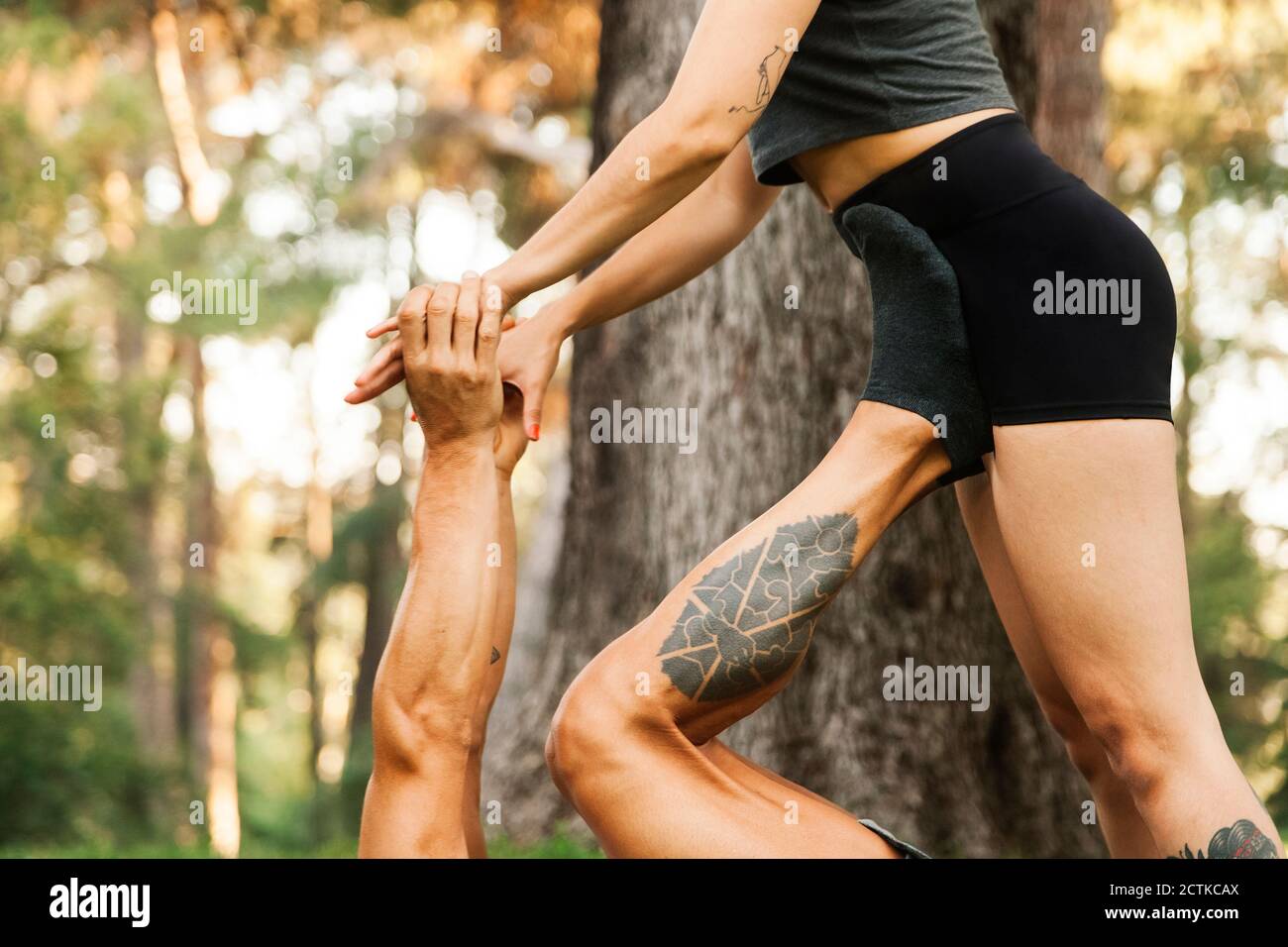 Male and female athletes practicing acroyoga in park Stock Photo - Alamy