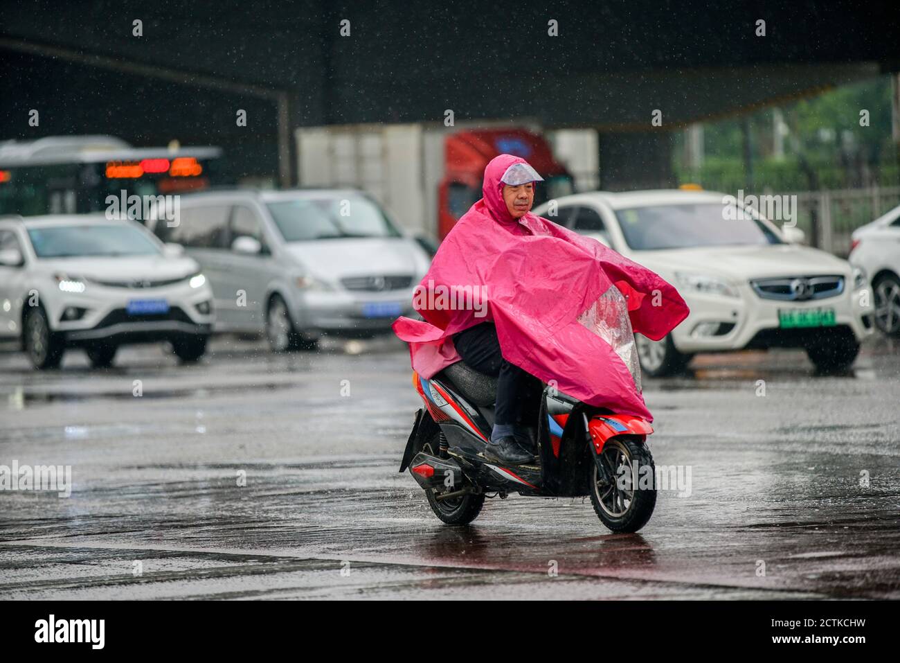Motor, pedestrians and vehicles trek in the downpour, Beijing, China ...