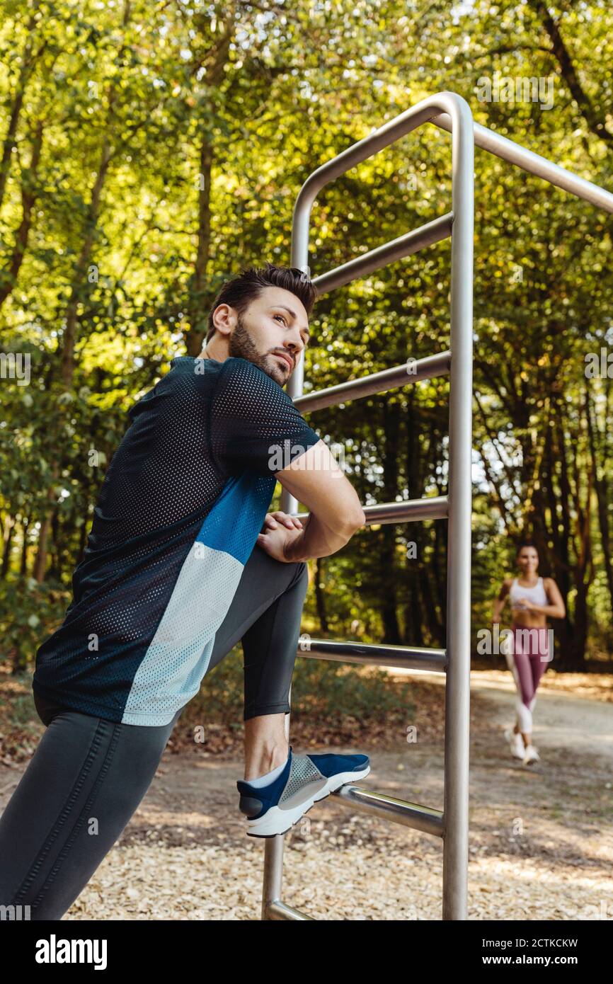 Man stretching on fitness trail Stock Photo - Alamy
