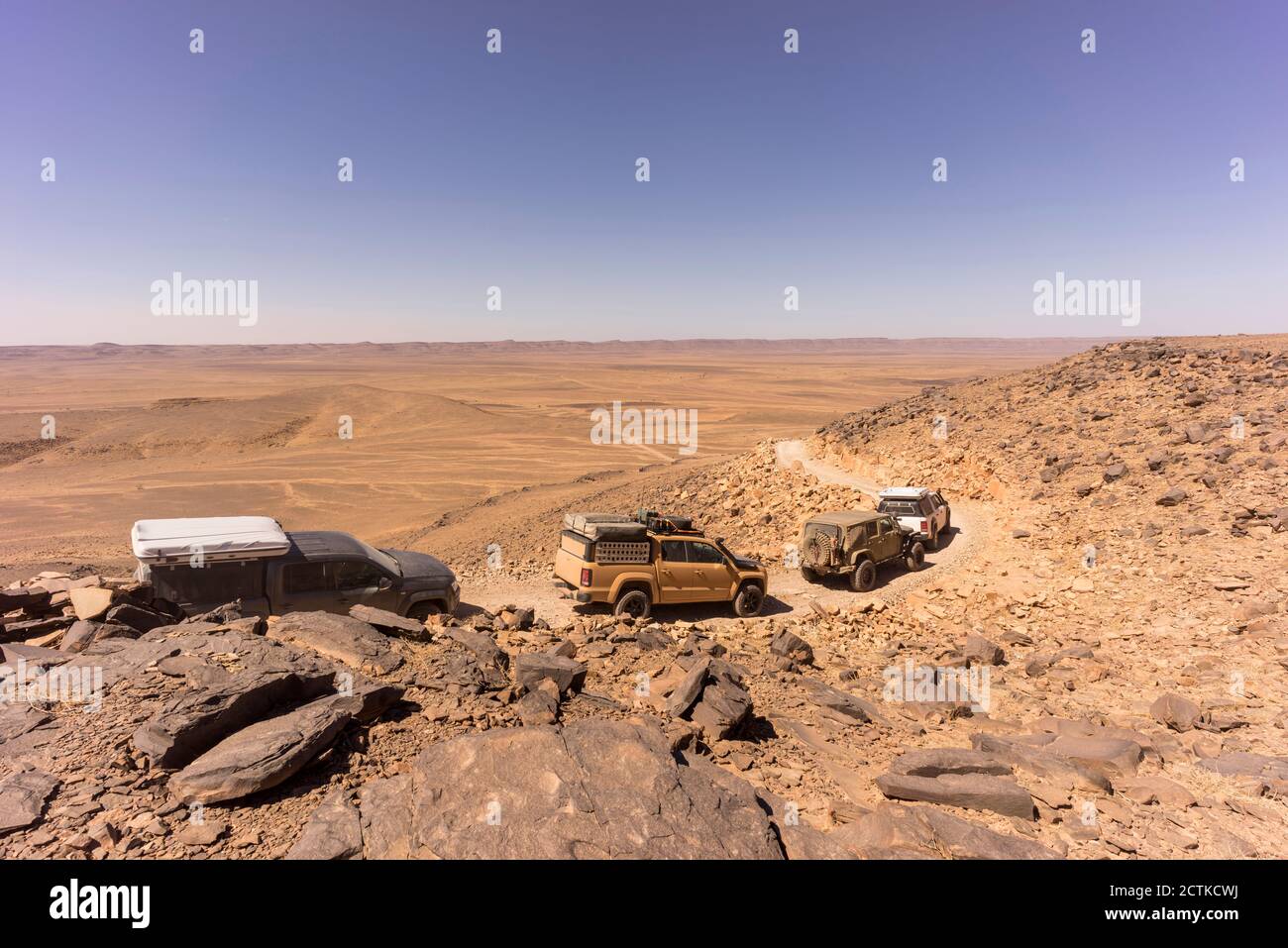 Off-road cars traversing rocky desert terrain Stock Photo - Alamy