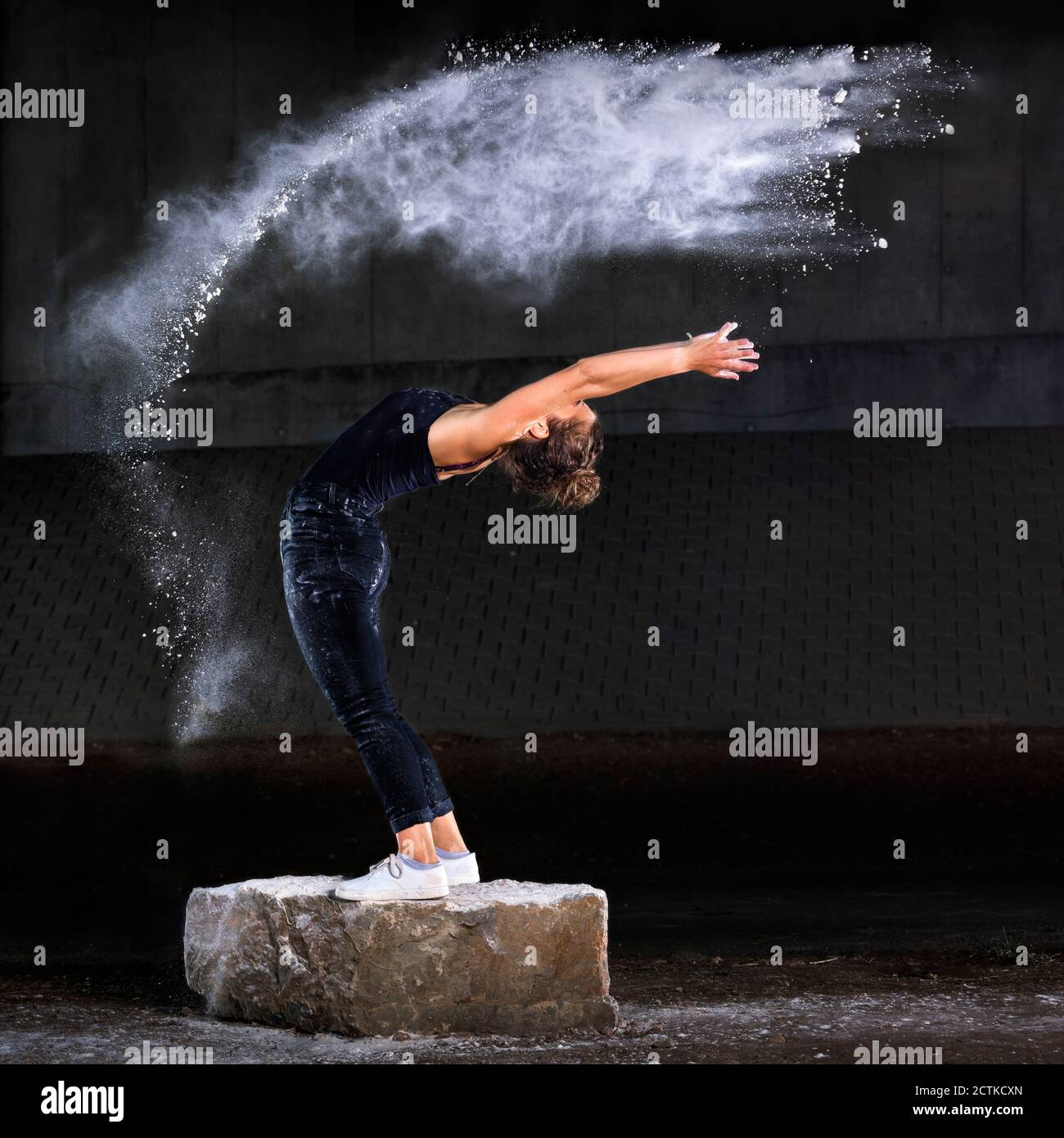 Woman dancing with flour against wall Stock Photo - Alamy