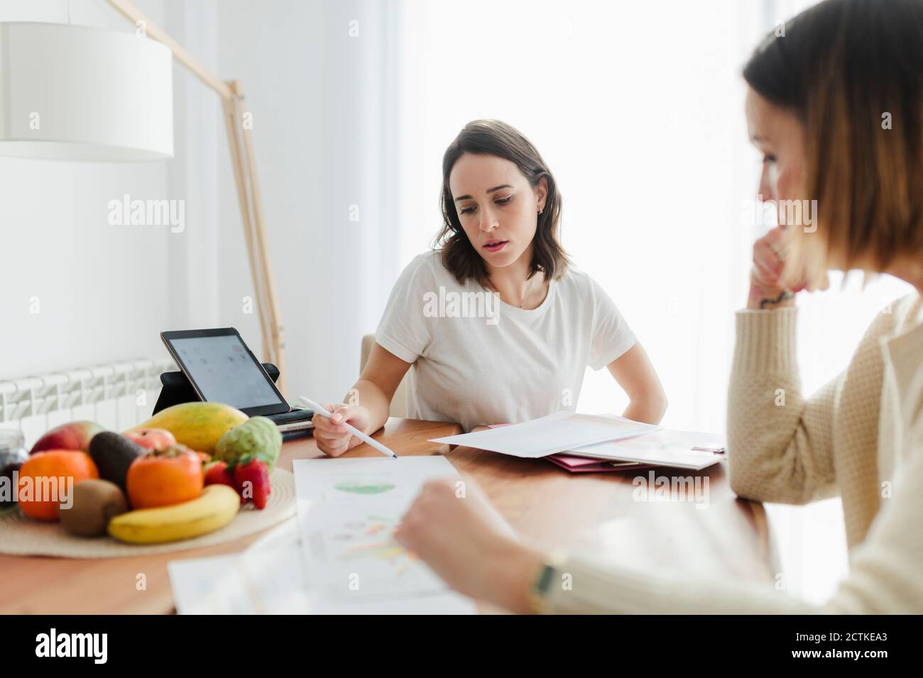 Women learning about food nutrition together at home Stock Photo - Alamy