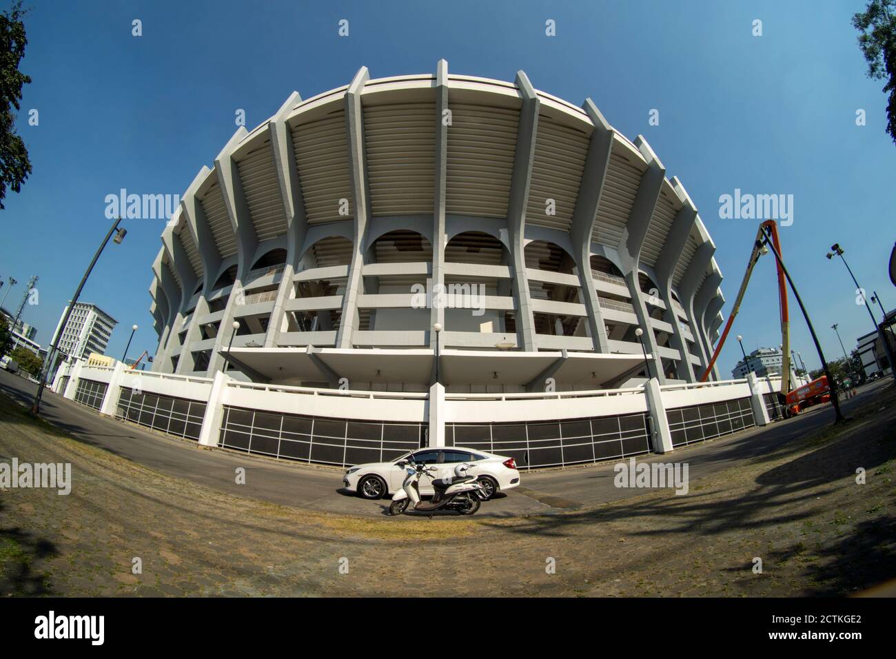 Stadium architecture with white motor bike and car Stock Photo - Alamy