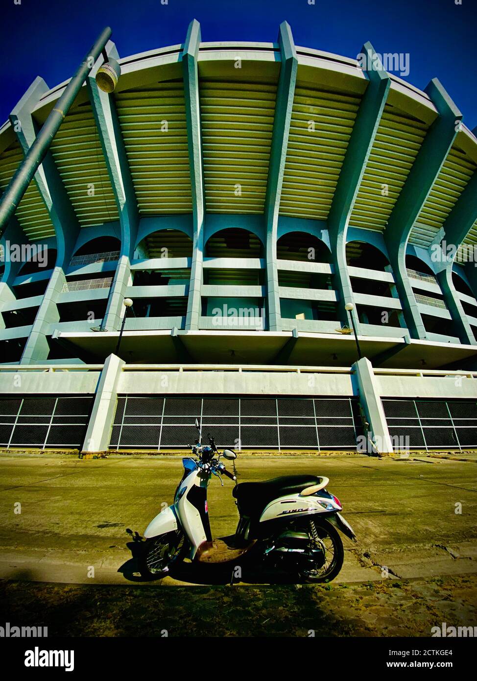 Stadium architecture with white motor bike Stock Photo - Alamy
