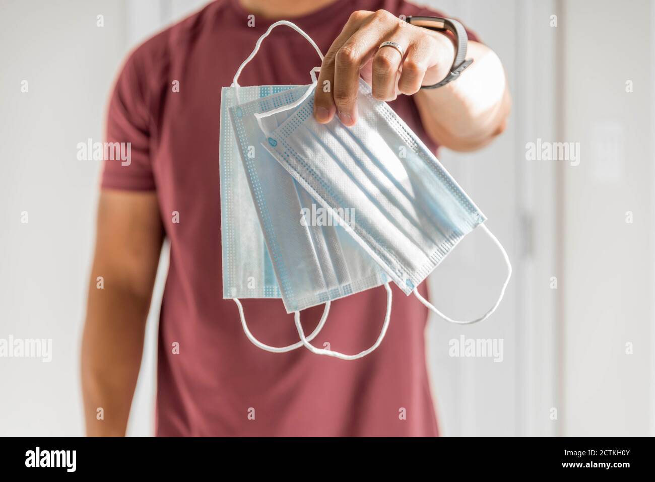 Hand giving free face mask for protection Stock Photo - Alamy