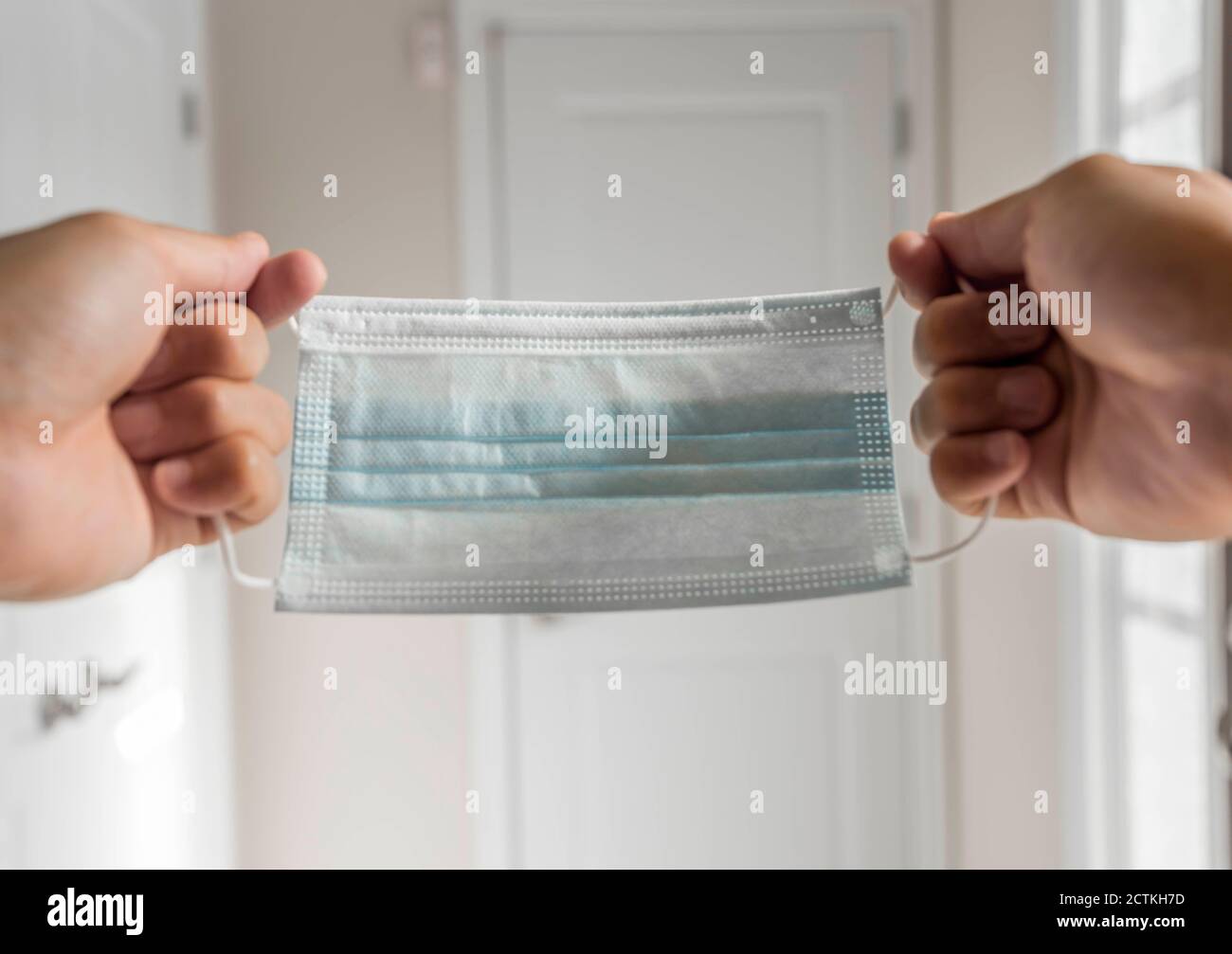 Putting face mask hi-res stock photography and images - Alamy