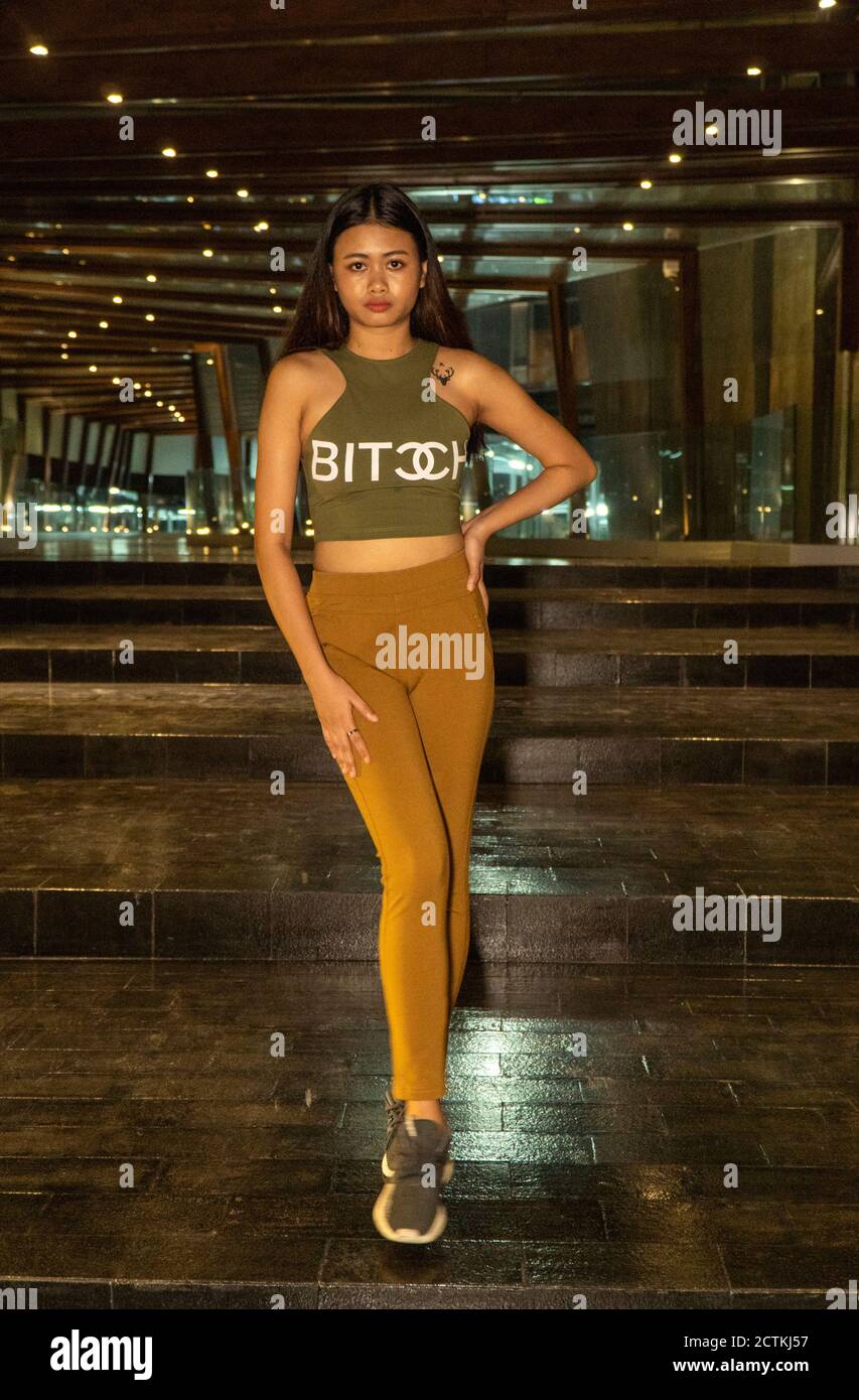 Teenage girl night posing for camera in dark lite walkway Stock Photo ...