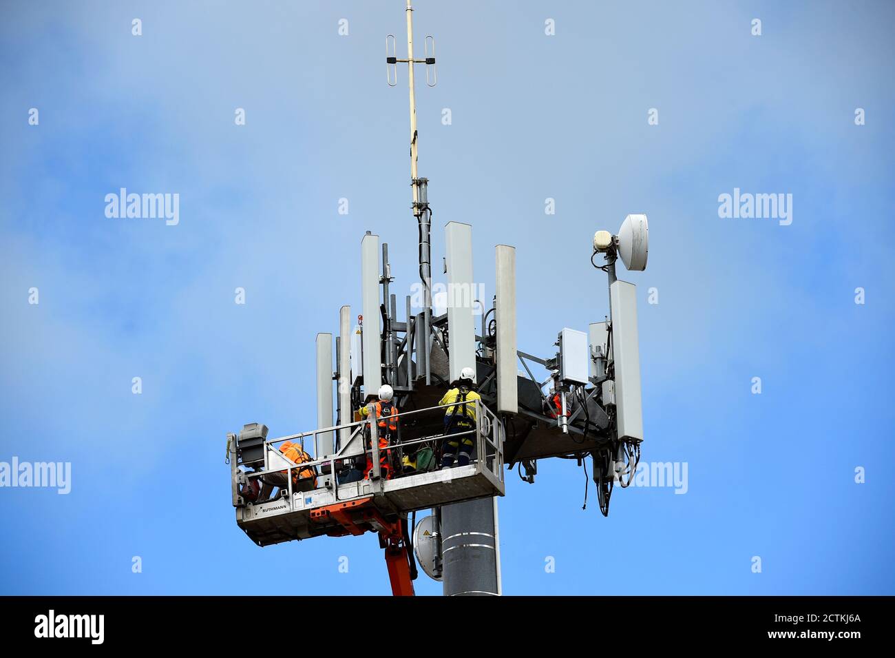 Telephone engineers upgrade the communications mast with new equipment ...