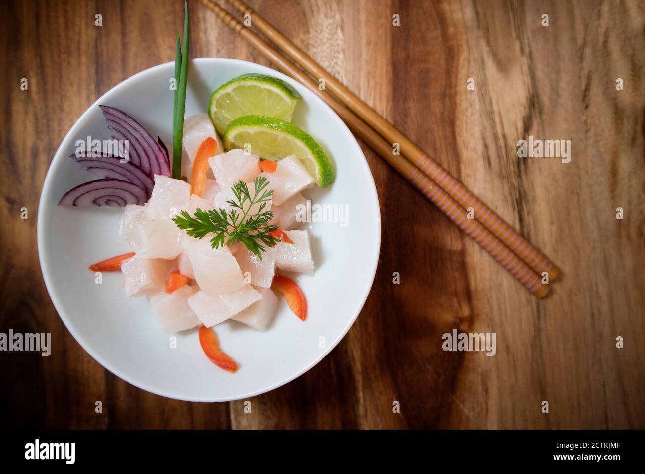 Traditional Ceviche bowl with white fish. Top view on wooden background ...