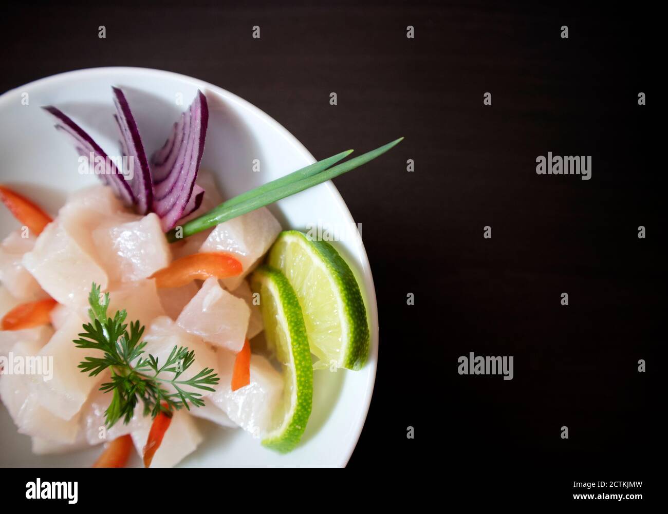 Traditional Ceviche bowl with white fish. Top view on dark background ...