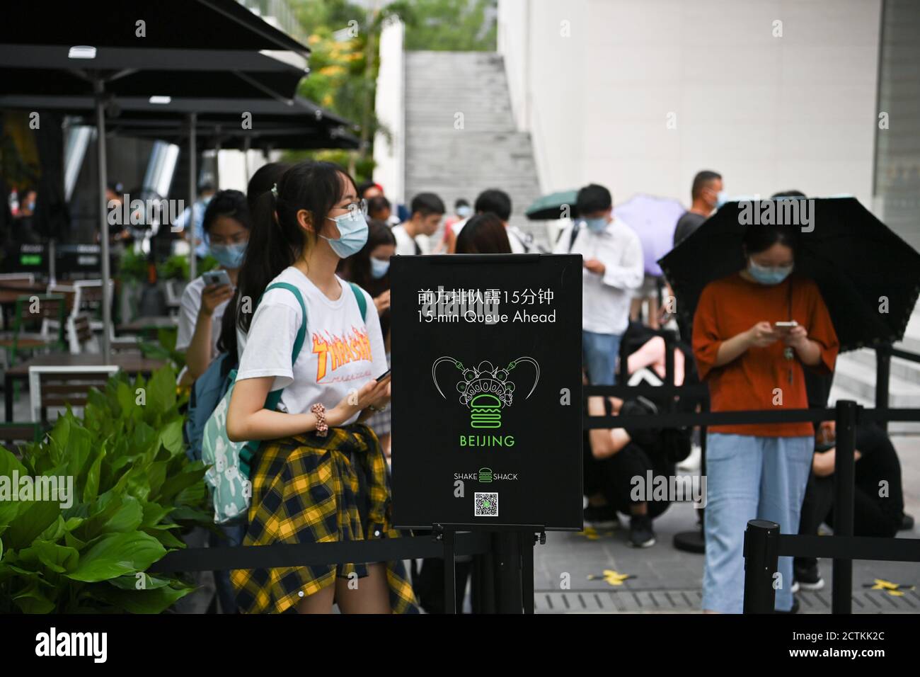People line up to get burgers at the Shake Shack store at Sanlitun in ...