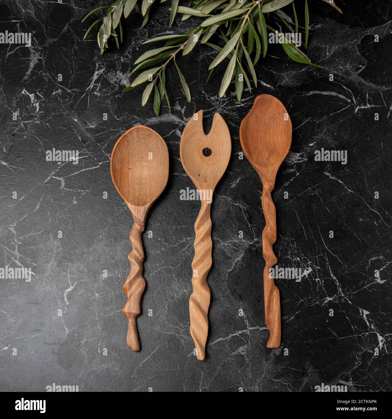 handmade wooden spoons on black marble Stock Photo - Alamy