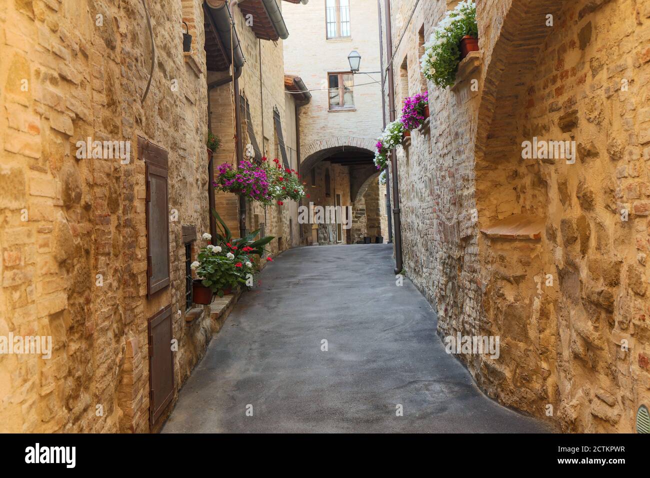 Bettona, Umbria region, Italy. Beautiful narrow street along sone ...