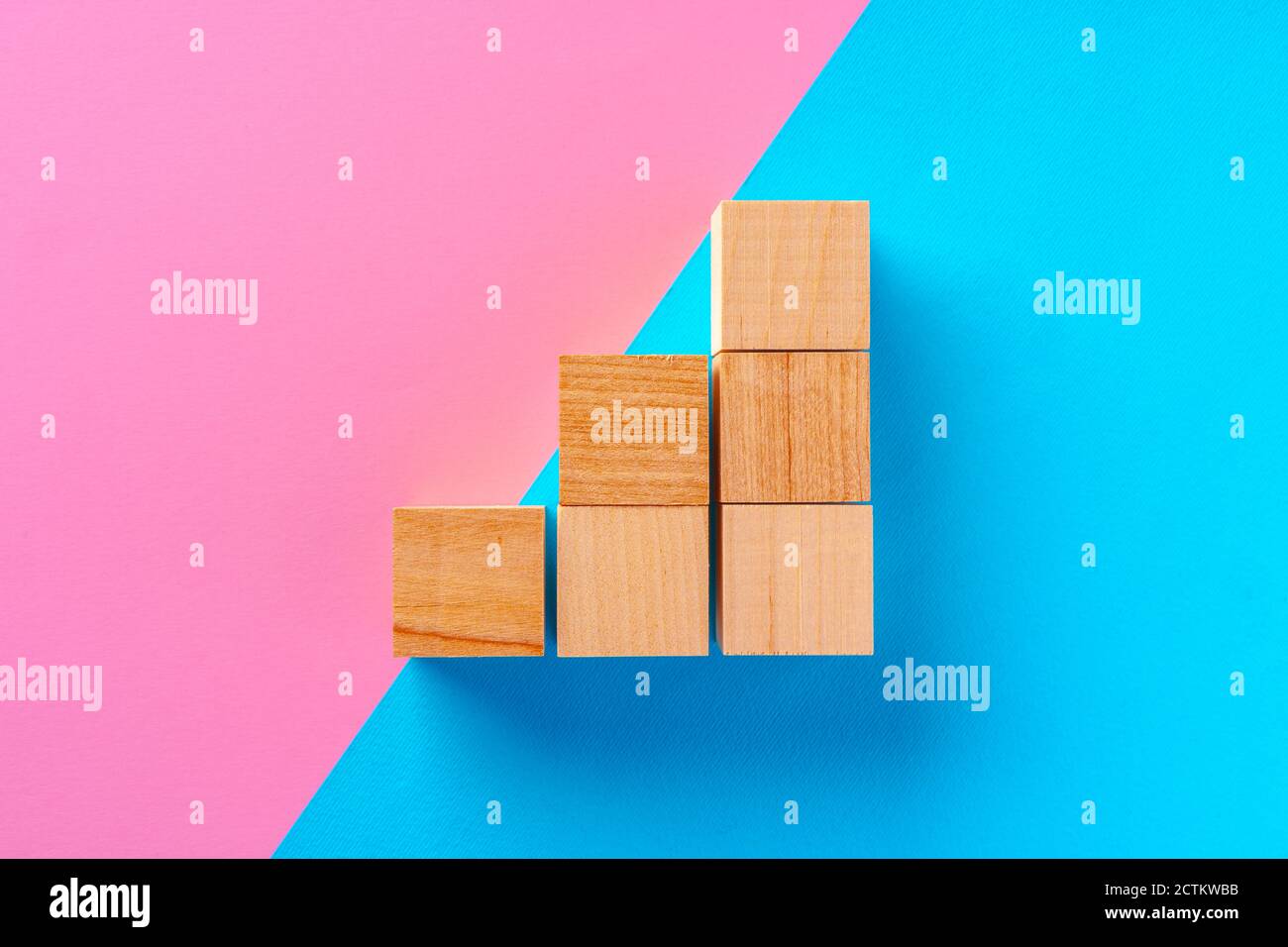 Top view photo of wooden blocks on pink and blue Stock Photo - Alamy