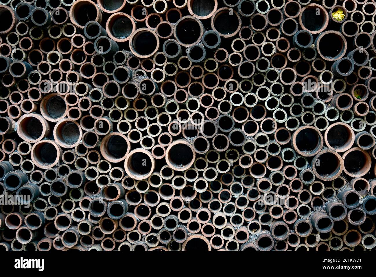 earthenware clay work with the circle tube shap are stick on the wall ...