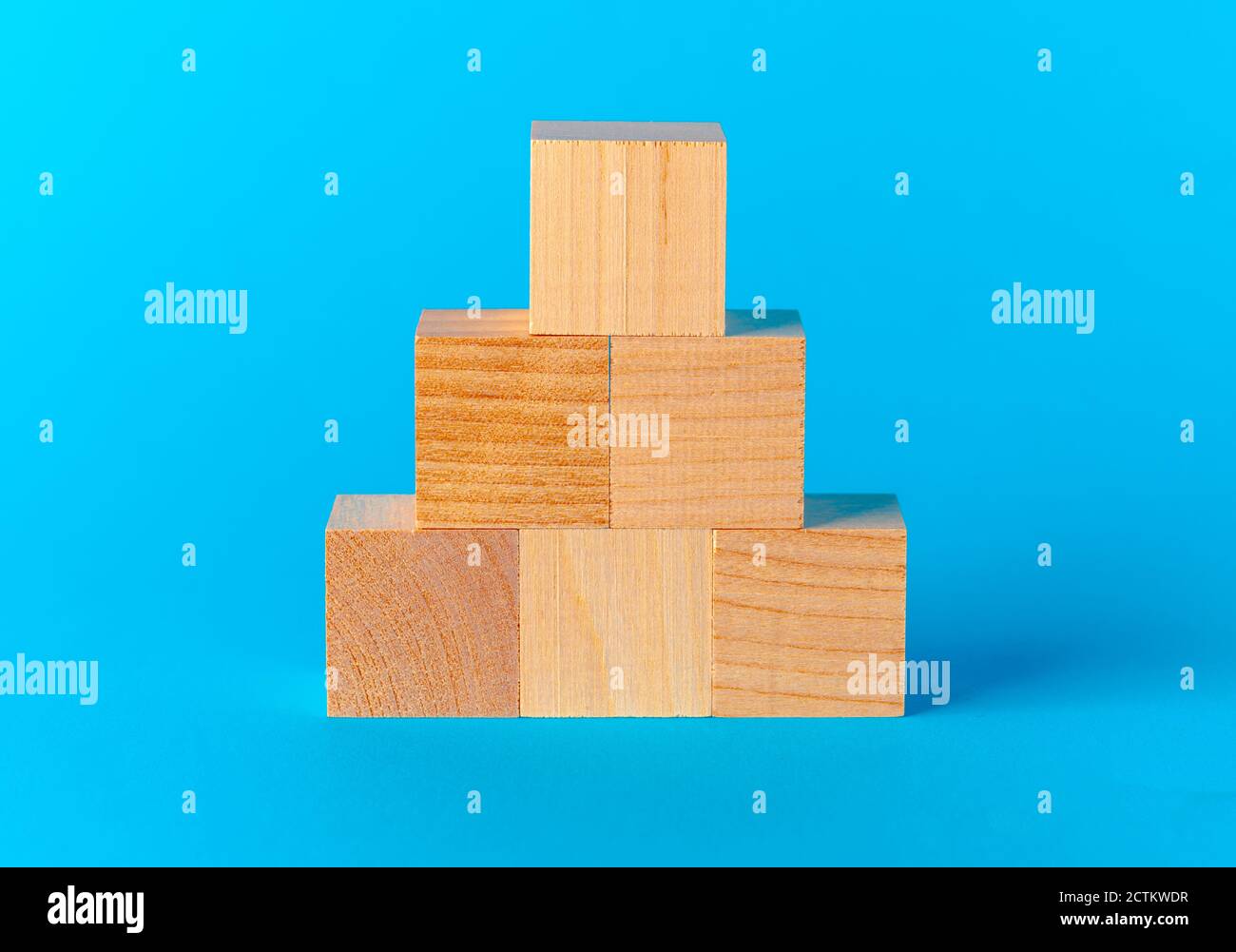 Toy wooden blocks on blue background front view Stock Photo - Alamy
