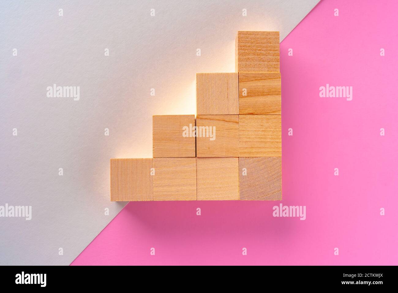 Wooden square block on pink and white background Stock Photo - Alamy