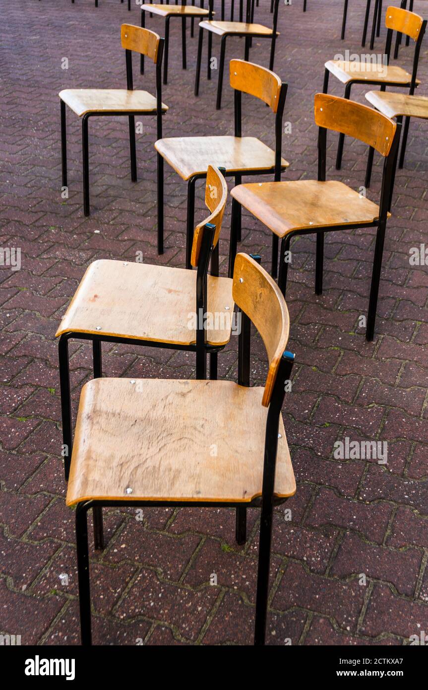 Vertical shot of school chairs on the ground Stock Photo - Alamy