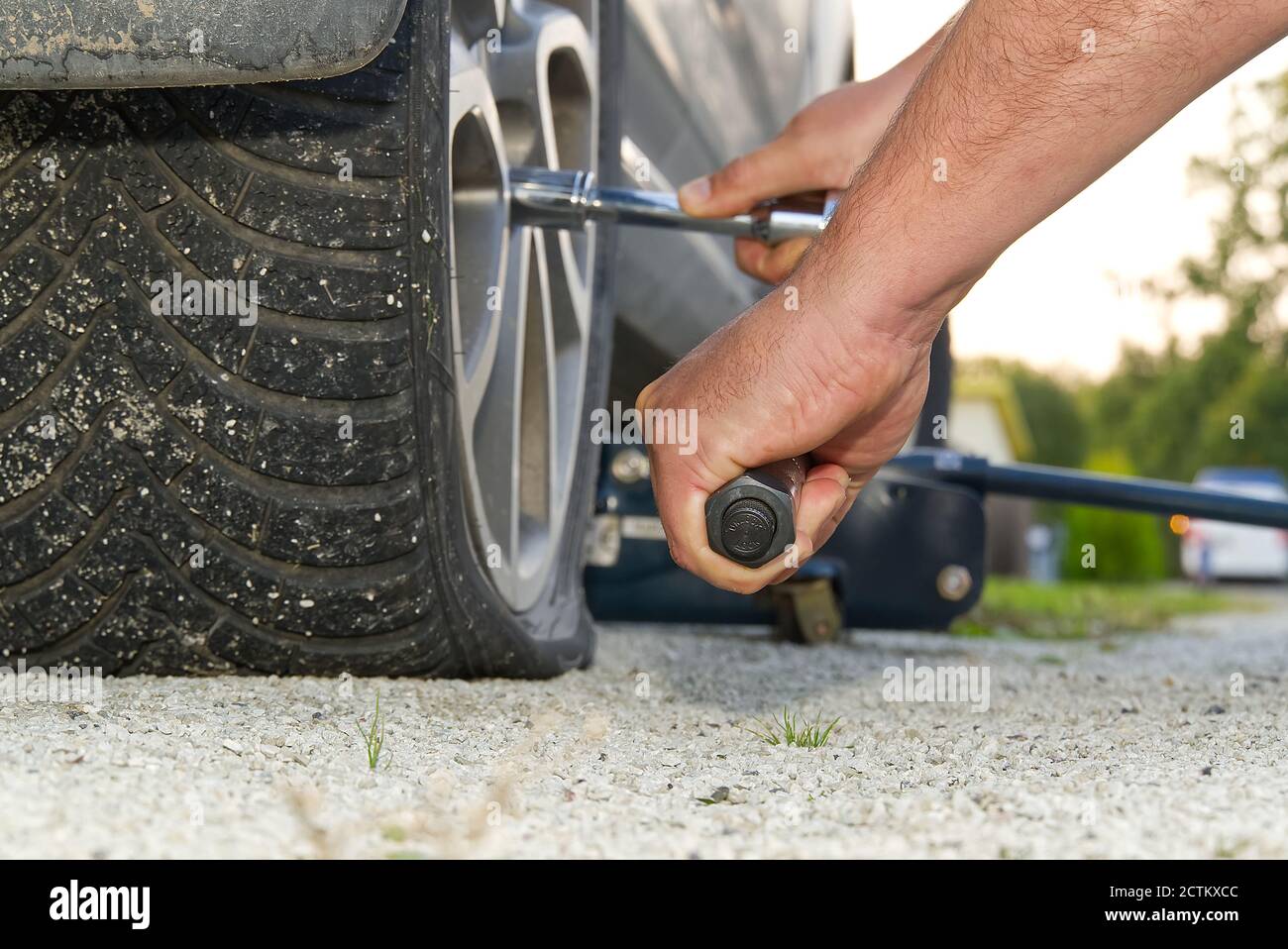Man changing wheel. tire changer changing flat car tire. Help on road ...