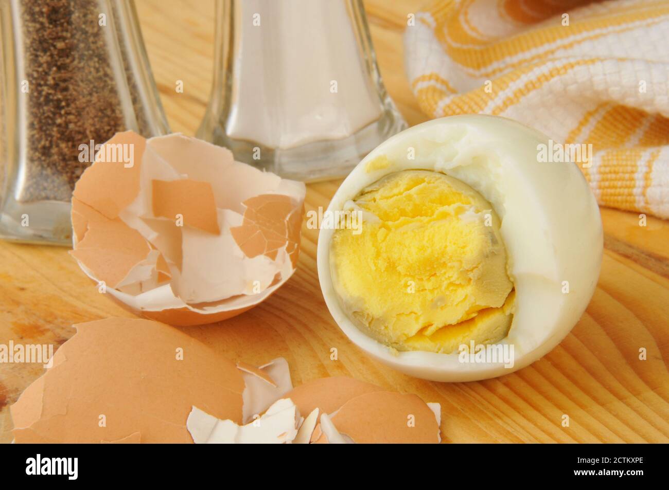 A hard boiled brown egg with pieces of the shell Stock Photo - Alamy