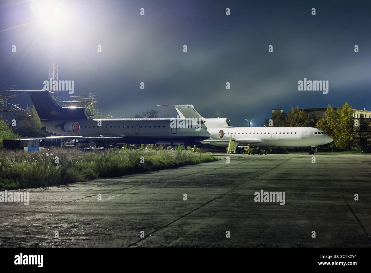 Planes maintenance on the aviation technical base at night Stock Photo ...
