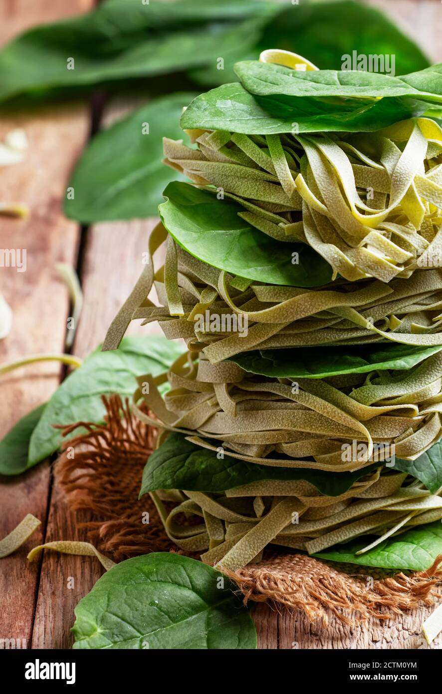Dry spinach pasta with green leaves, folded like a tower, vintage ...