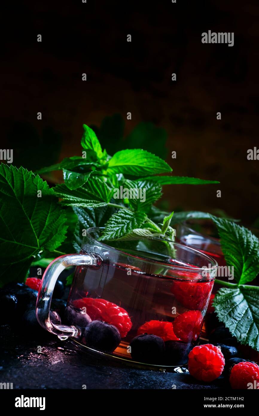 Cold green tea with forest berries and leaves, selective focus Stock ...