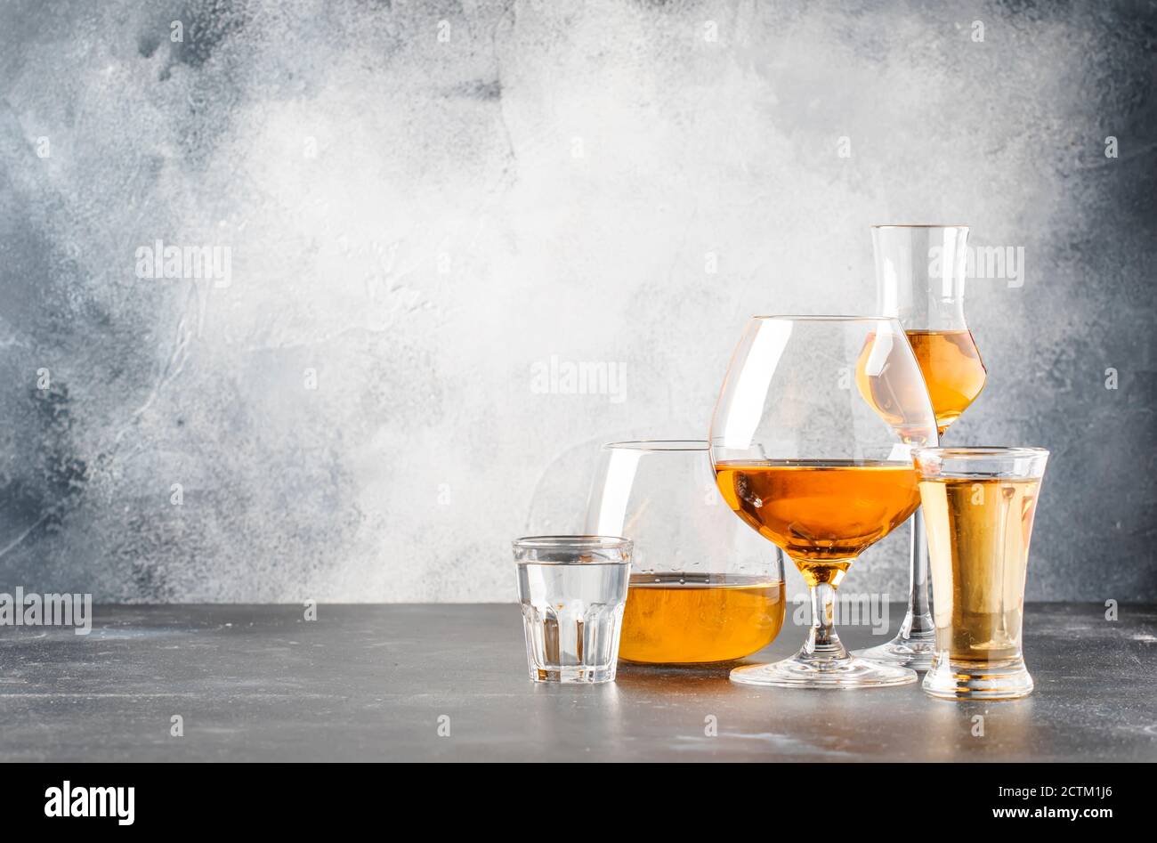 Set of hard strong alcoholic drinks and spirits in glasses in ...