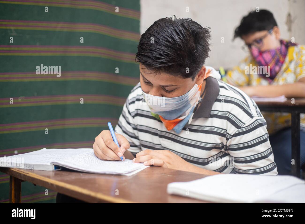 Indian boys students studying In classroom wearing mask maintaining ...