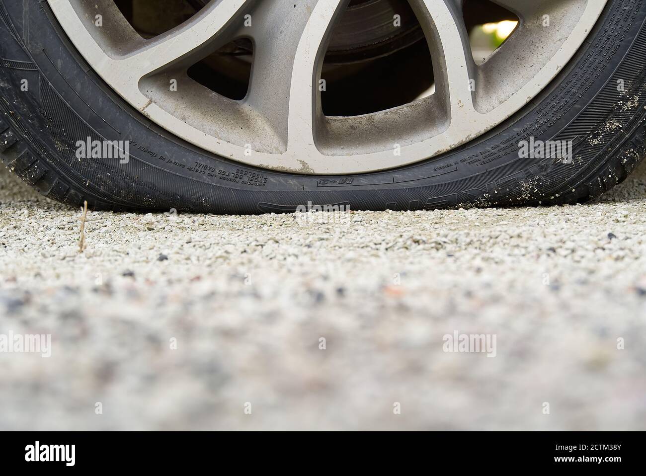 Close-up of Flat rear tire on car. The right rear broken weel. Damaged ...