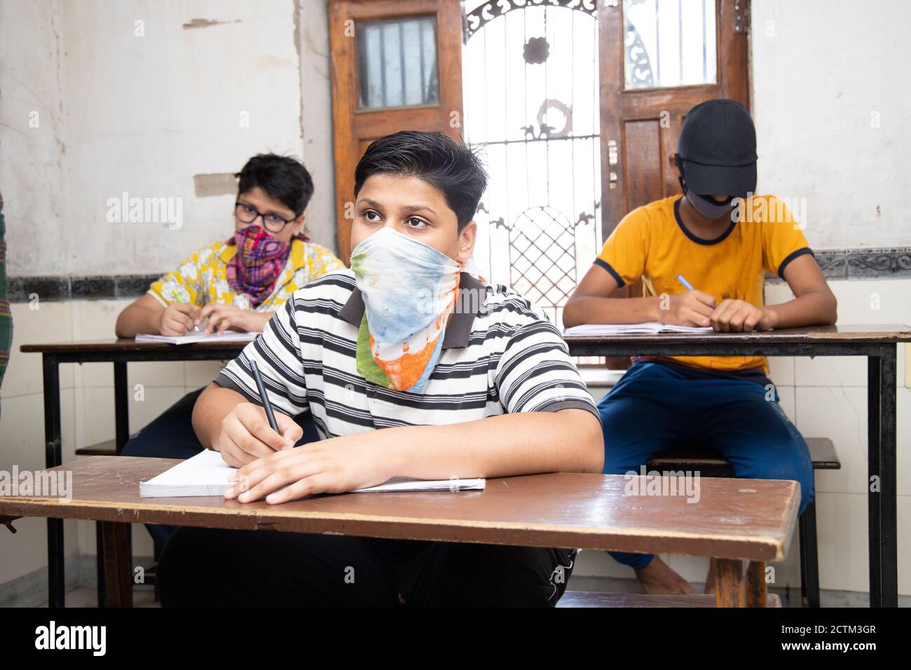 Indian Students wearing face masks maintaining social distancing at a ...