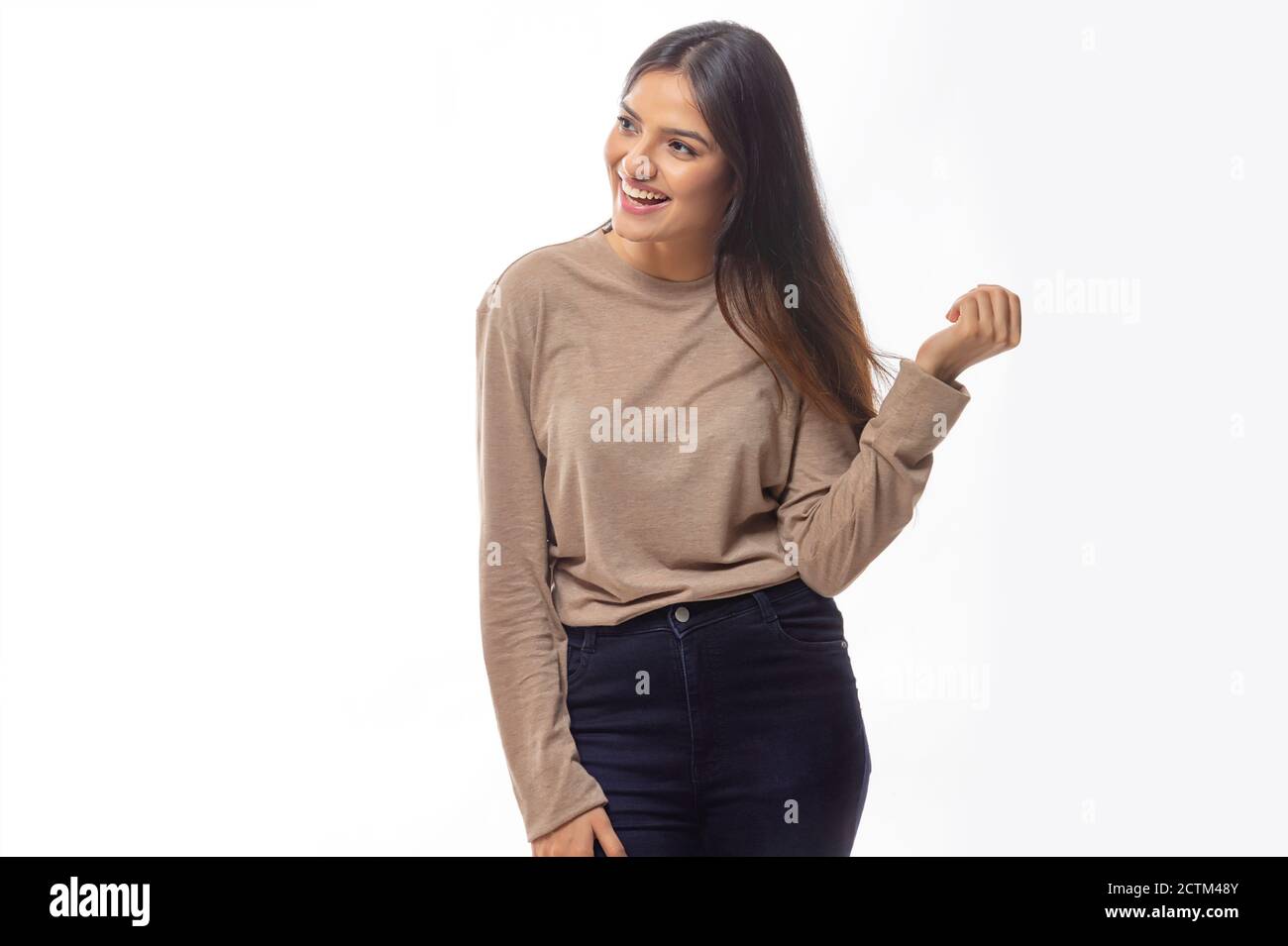 Beautiful woman looking sideways and smiling Stock Photo - Alamy