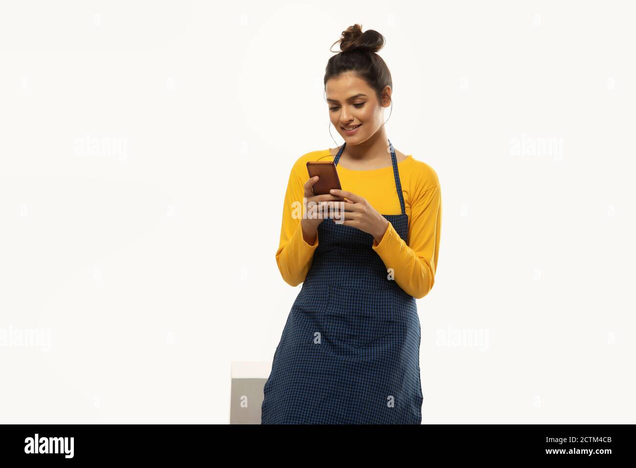 Woman smiling in apron standing hi-res stock photography and images - Alamy