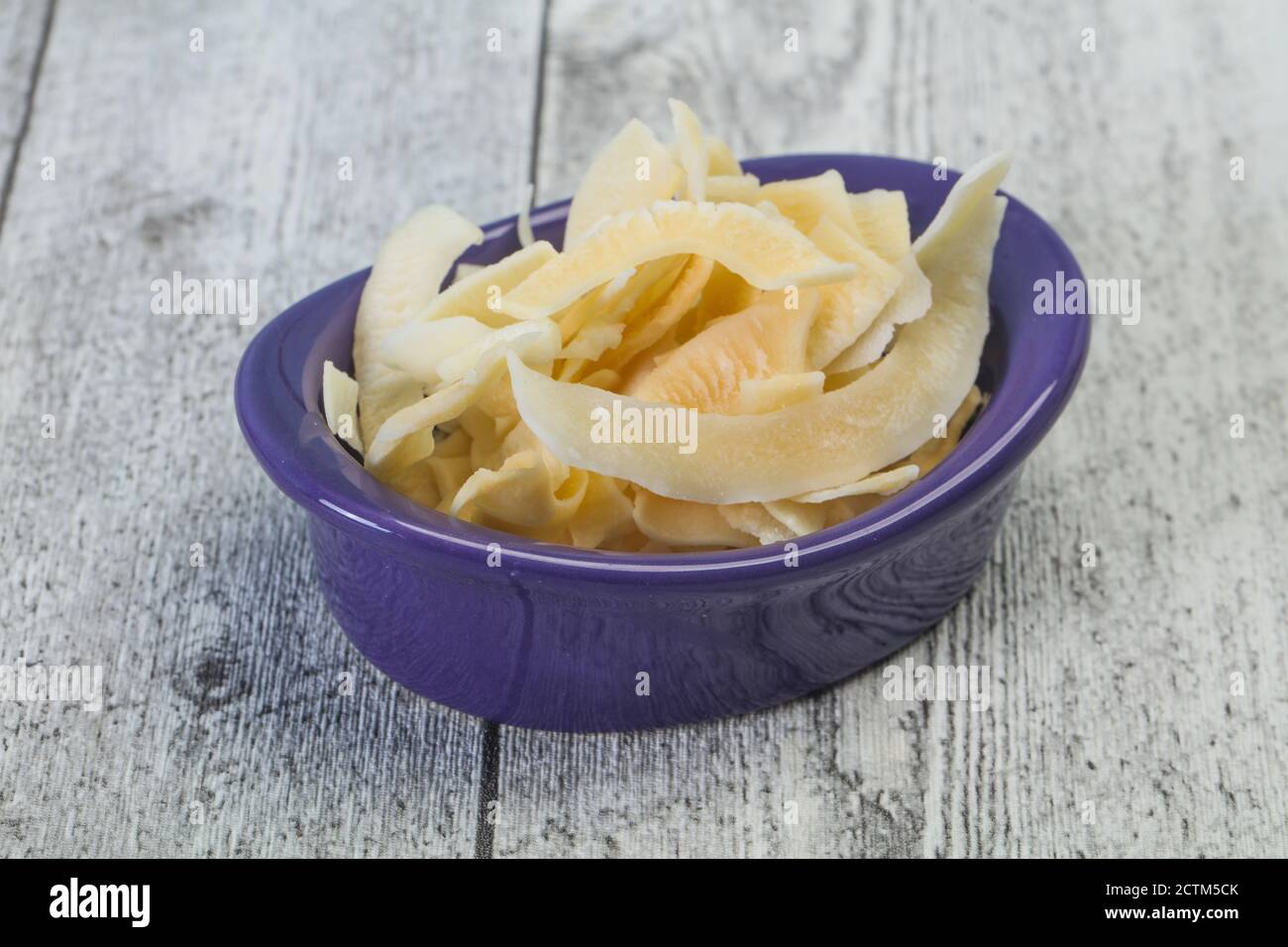 Coconut dry chips snack in the bowl Stock Photo - Alamy