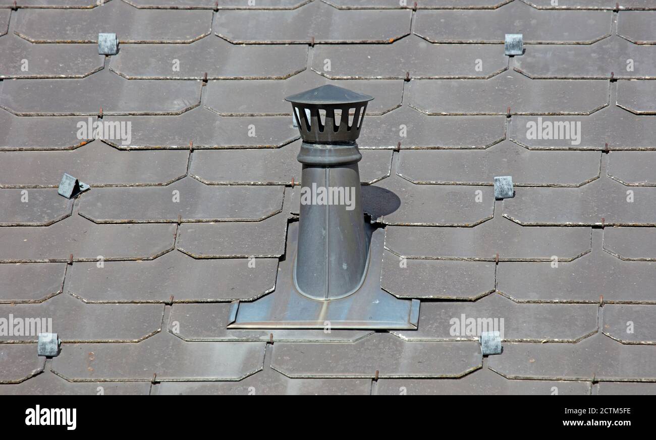 Modern chimney and roof, metal chimney, grey roof Stock Photo - Alamy