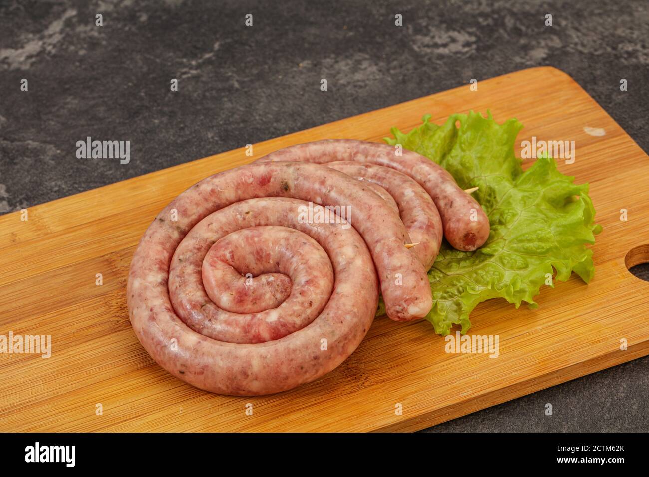 Raw pork sausage ring for grill Stock Photo - Alamy
