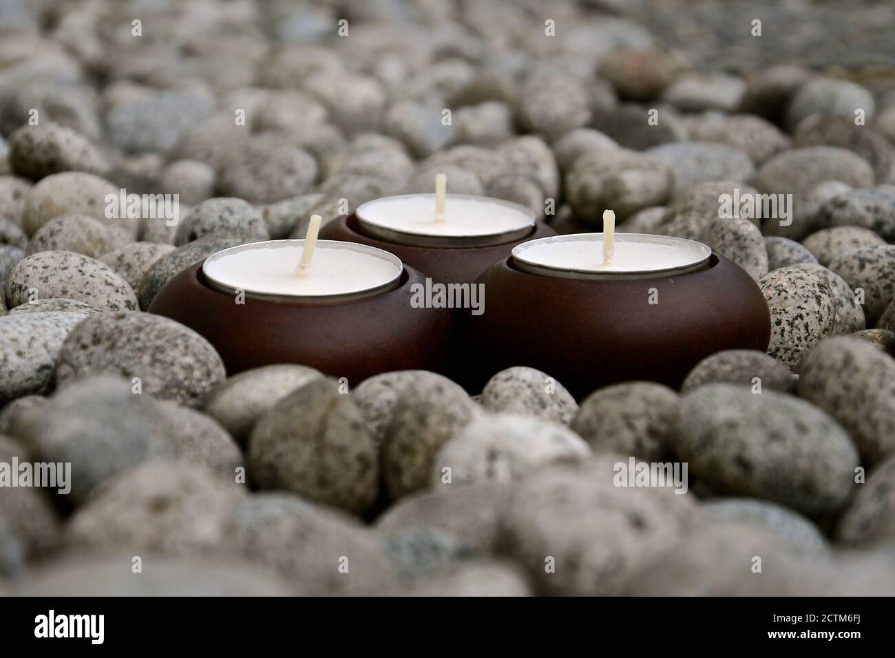 Perspective view of 3 tealight candles isolated against a background of ...